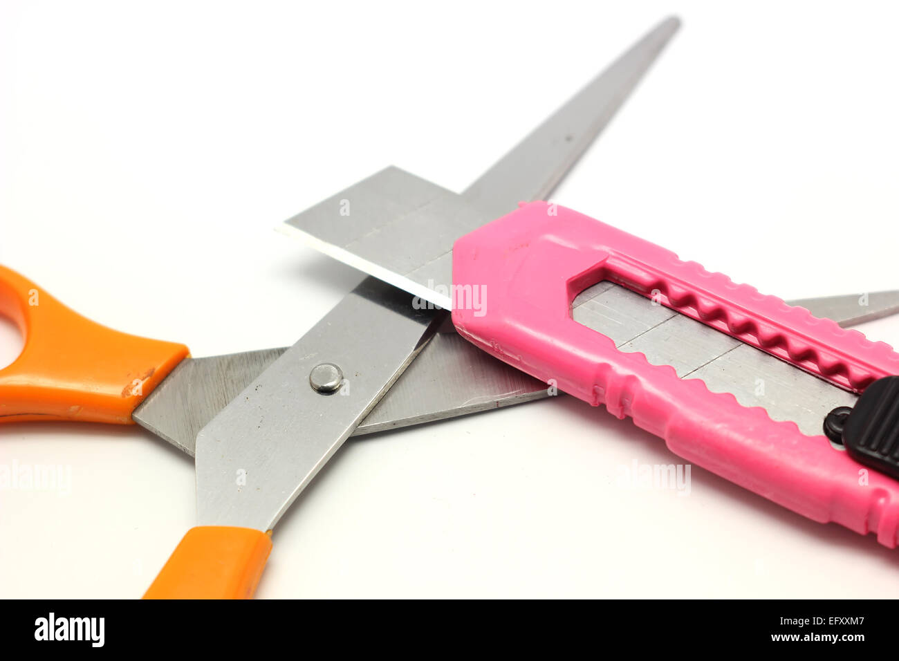 scissors and boxcutter isolated on white background Stock Photo - Alamy