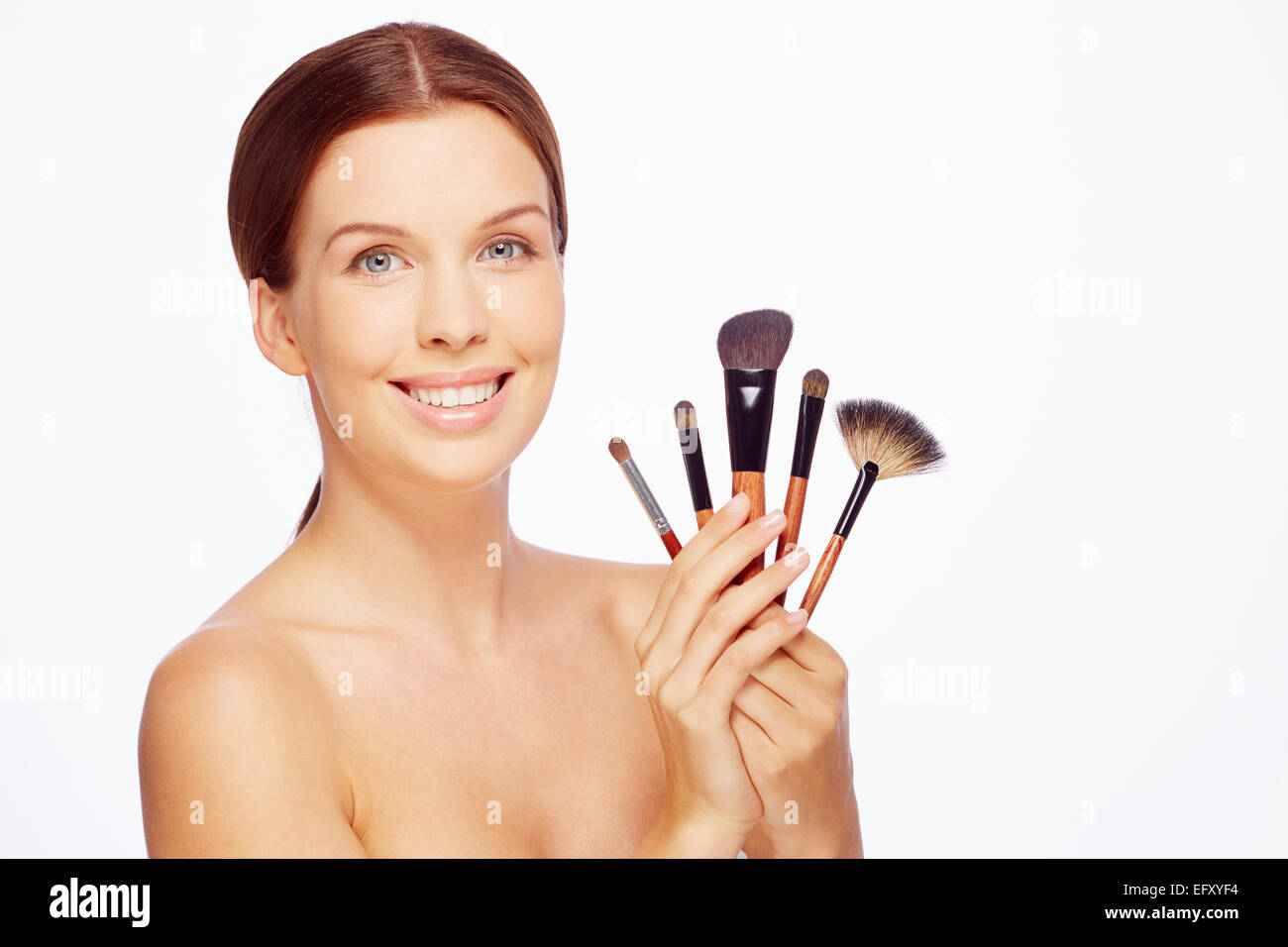 Portrait of young female with various brushes for makeup Stock Photo ...