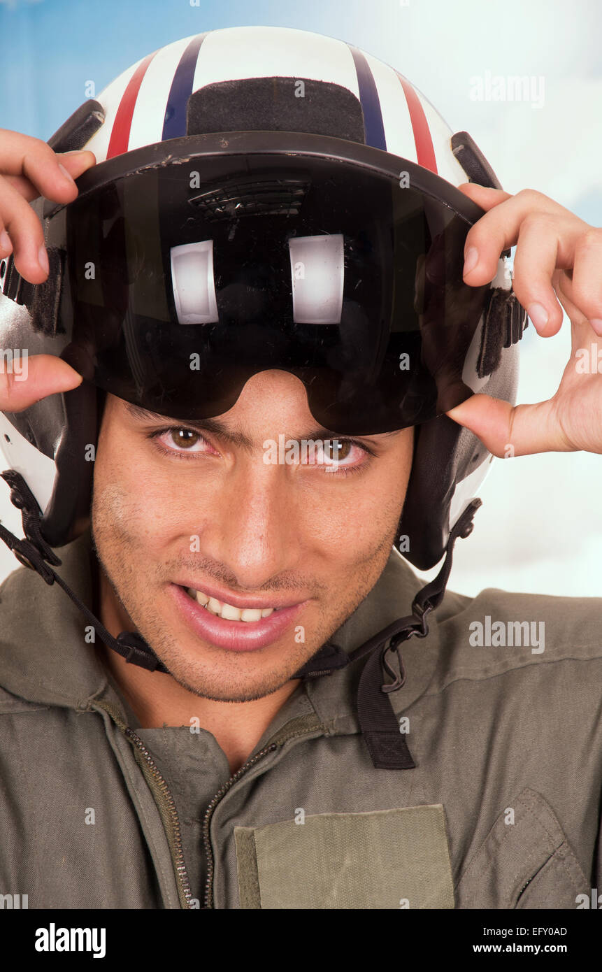 young handsome pilot wearing helmet over sky background Stock Photo - Alamy