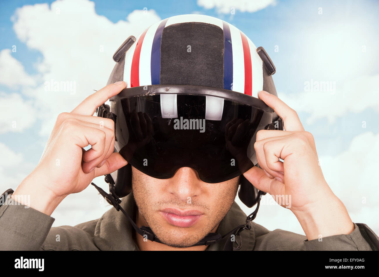young handsome pilot wearing helmet over sky background Stock Photo - Alamy