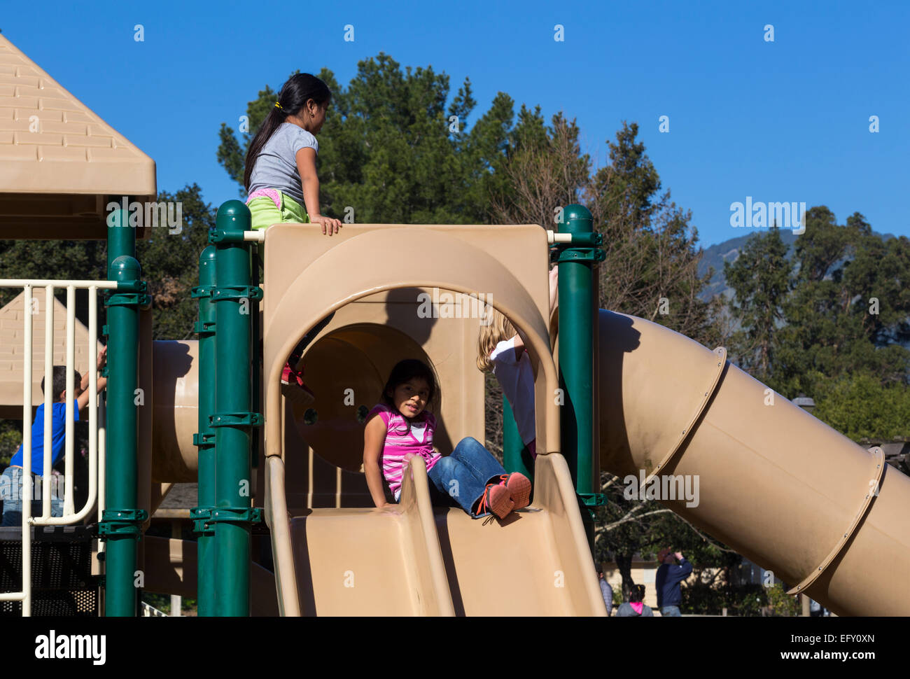 Hispanic girls, young girls, girls, sliding pond, playground, Pioneer Park, Novato, California ...