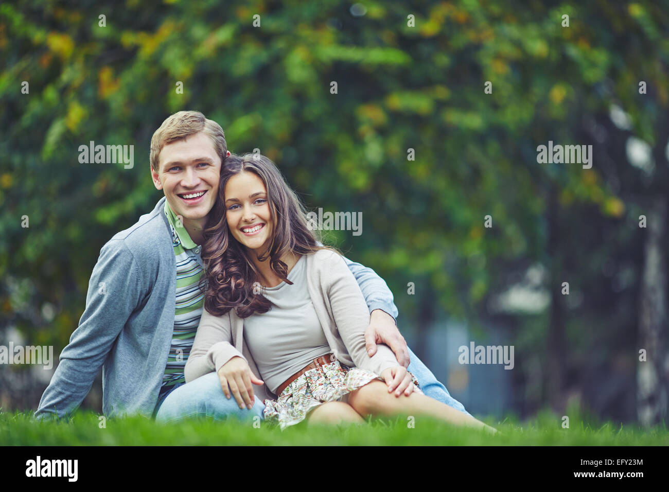 Romantic couple looking at camera in natural environment Stock Photo ...