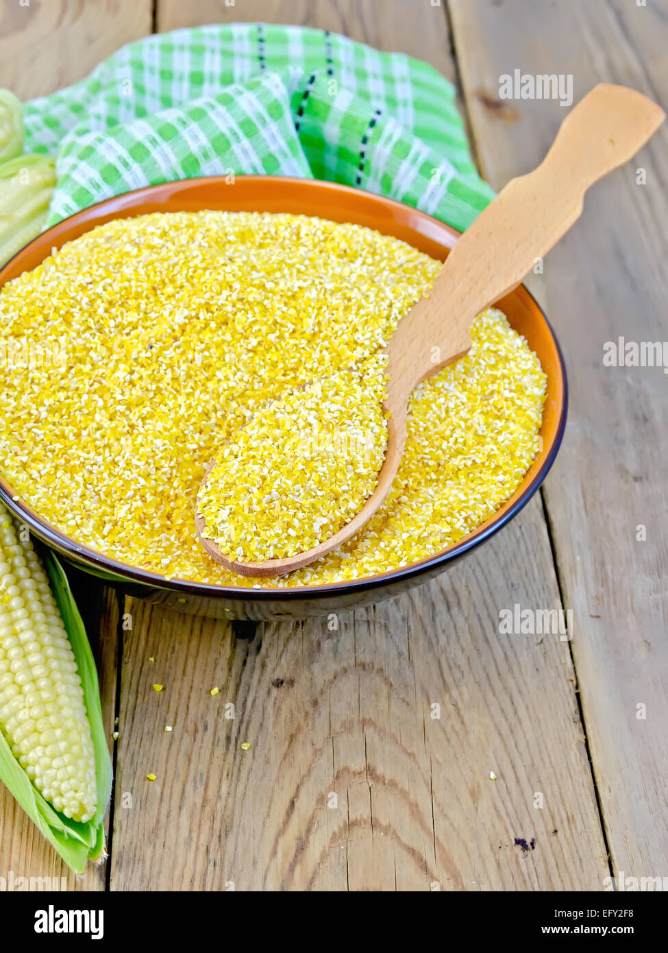 Corn grits with cob and spoon on board Stock Photo - Alamy