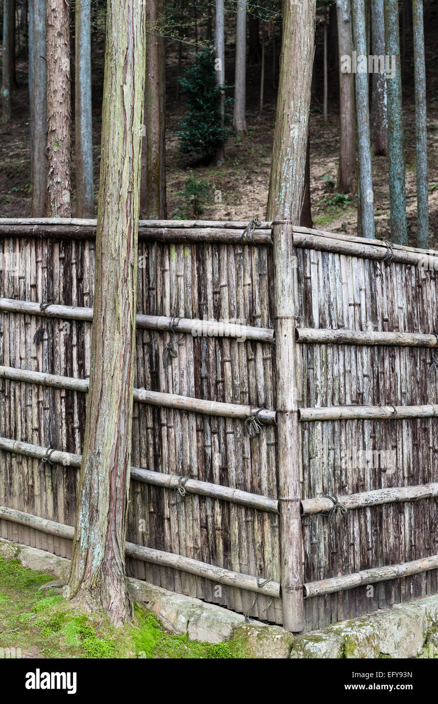 A traditional Japanese boundary fence of split bamboo surrounds the ...
