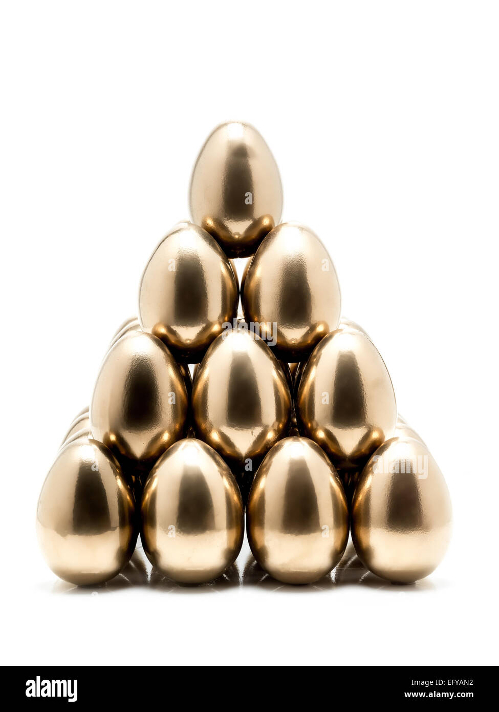 Pyramid of golden eggs on white background Stock Photo - Alamy
