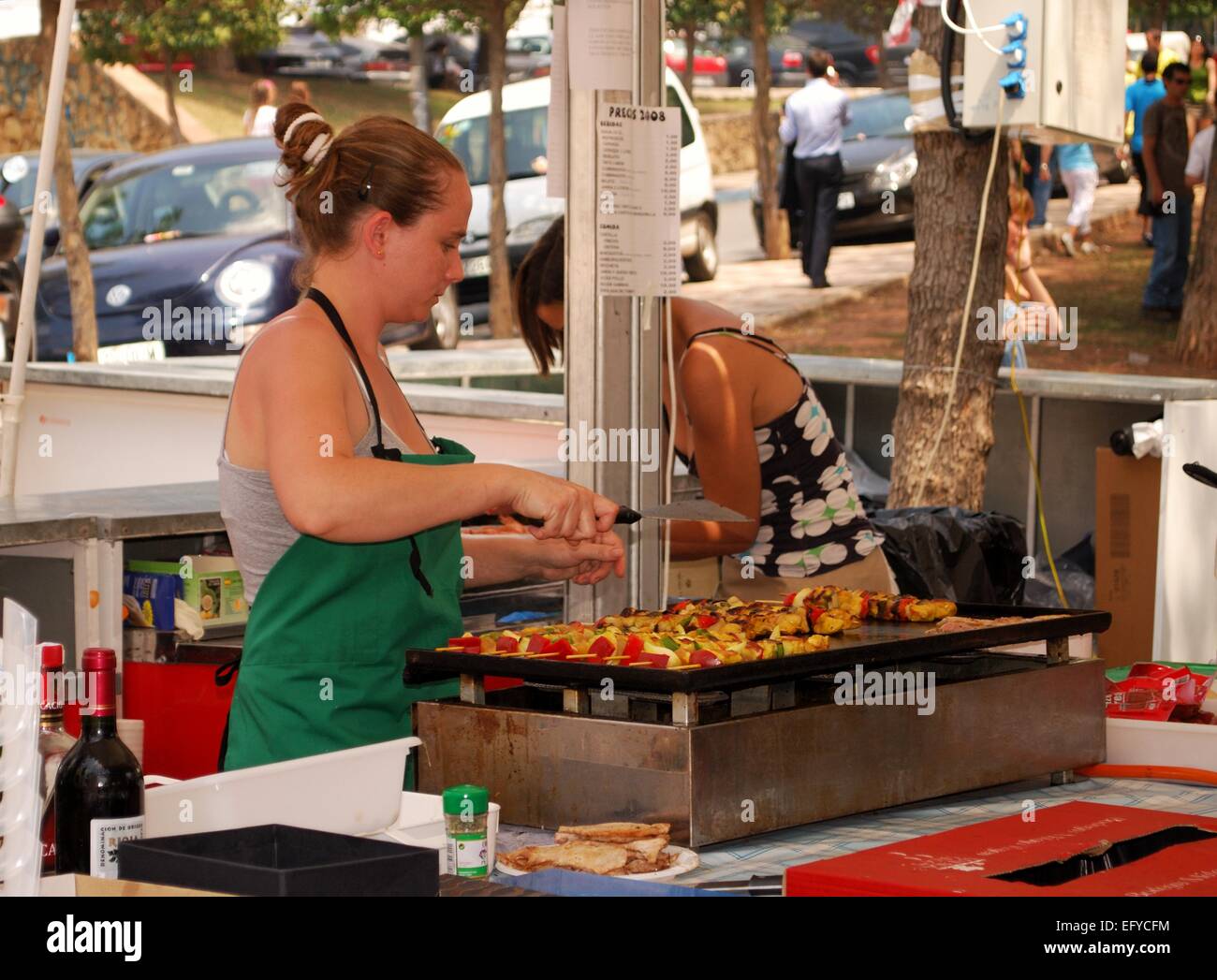 Chef cooking kebabs at a snack stall during the Romeria San Bernabe ...