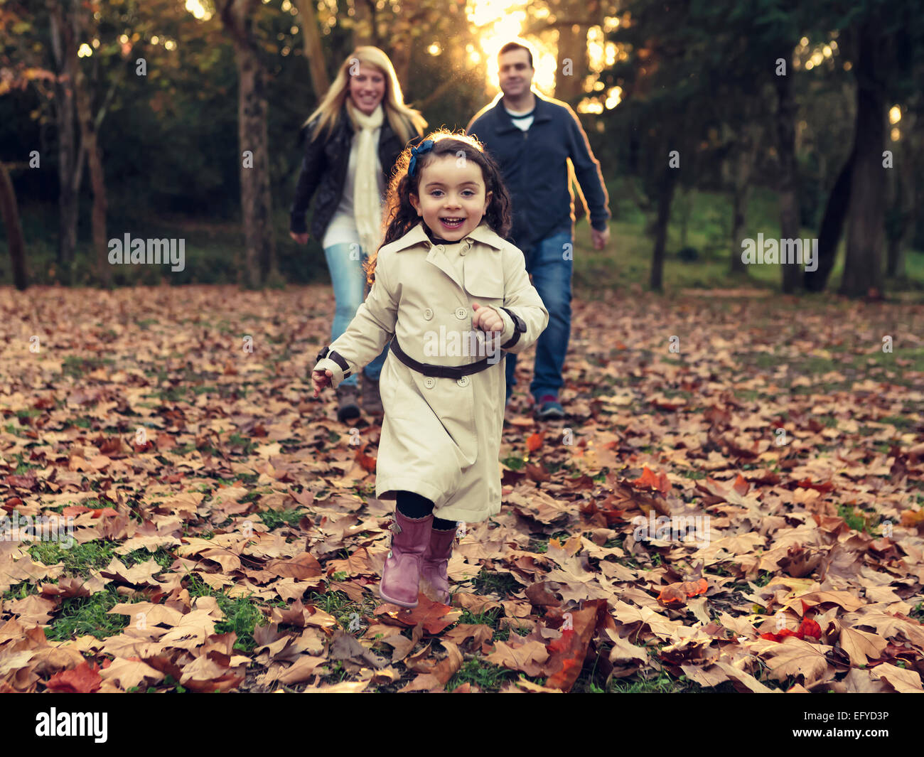 Outdoor portrait of a happy family enjoying the fall season Stock Photo ...