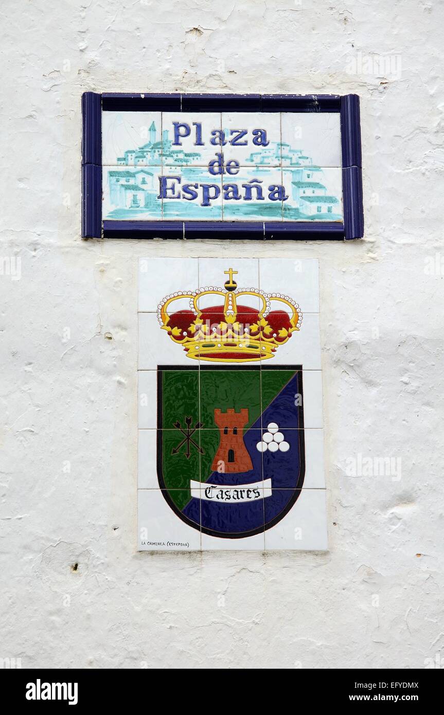Plaza de Espana sign and town crest on a white wall, Casares, Cadiz ...
