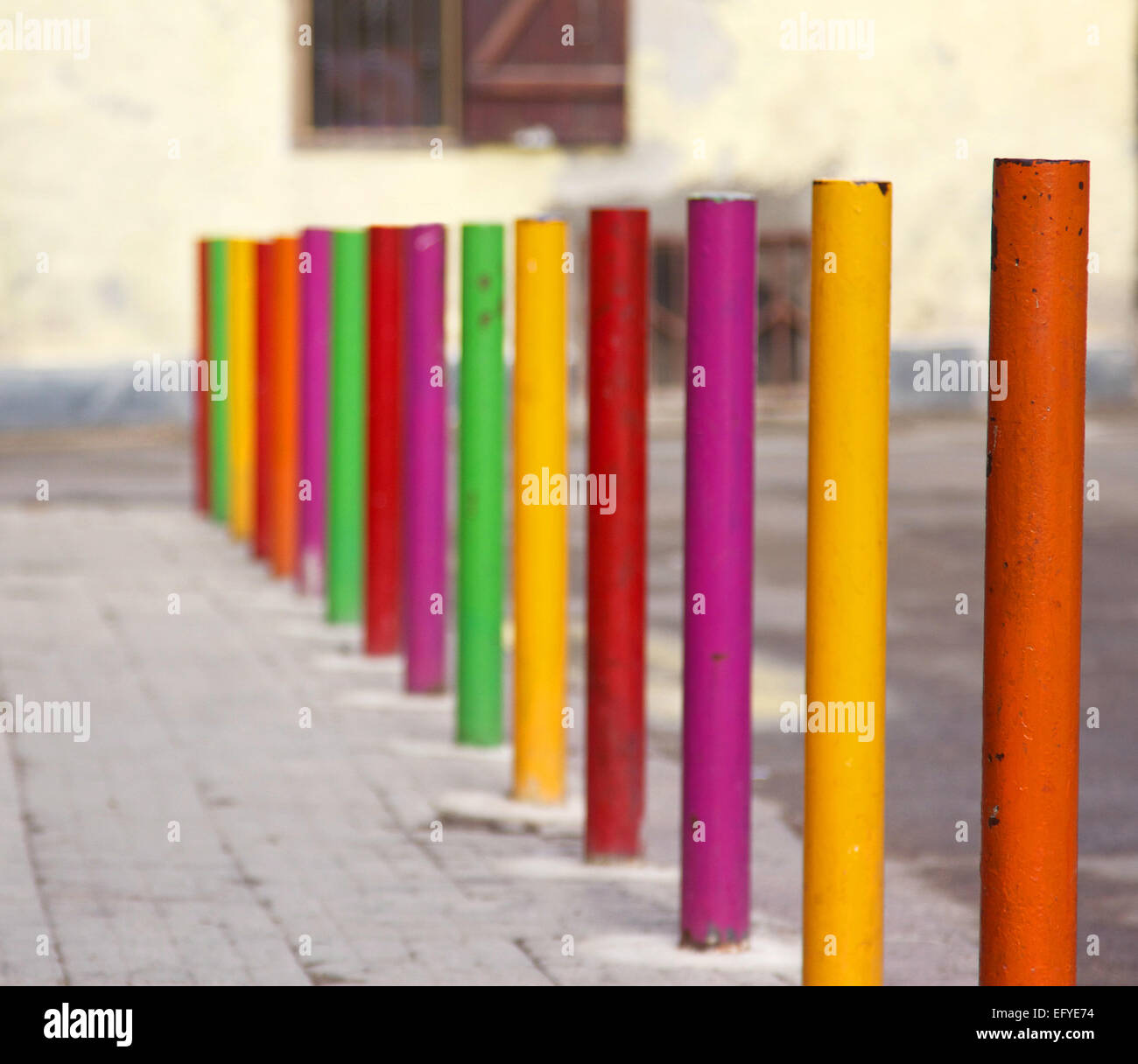 Colourful poles in a row Stock Photo - Alamy