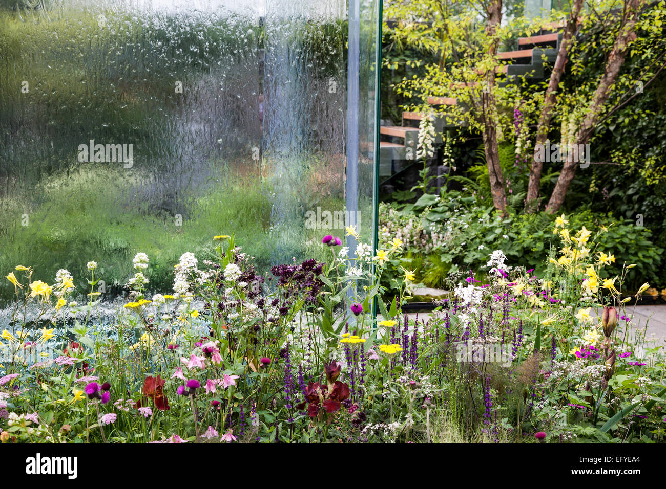 Pavilion with transparent water wall and mixed naturalistic planting ...