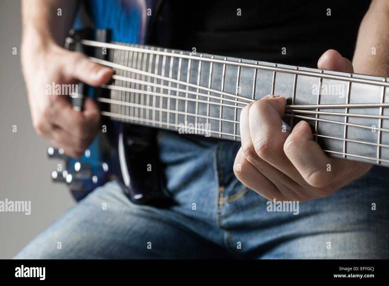 male musician playing on bass guitar Stock Photo - Alamy