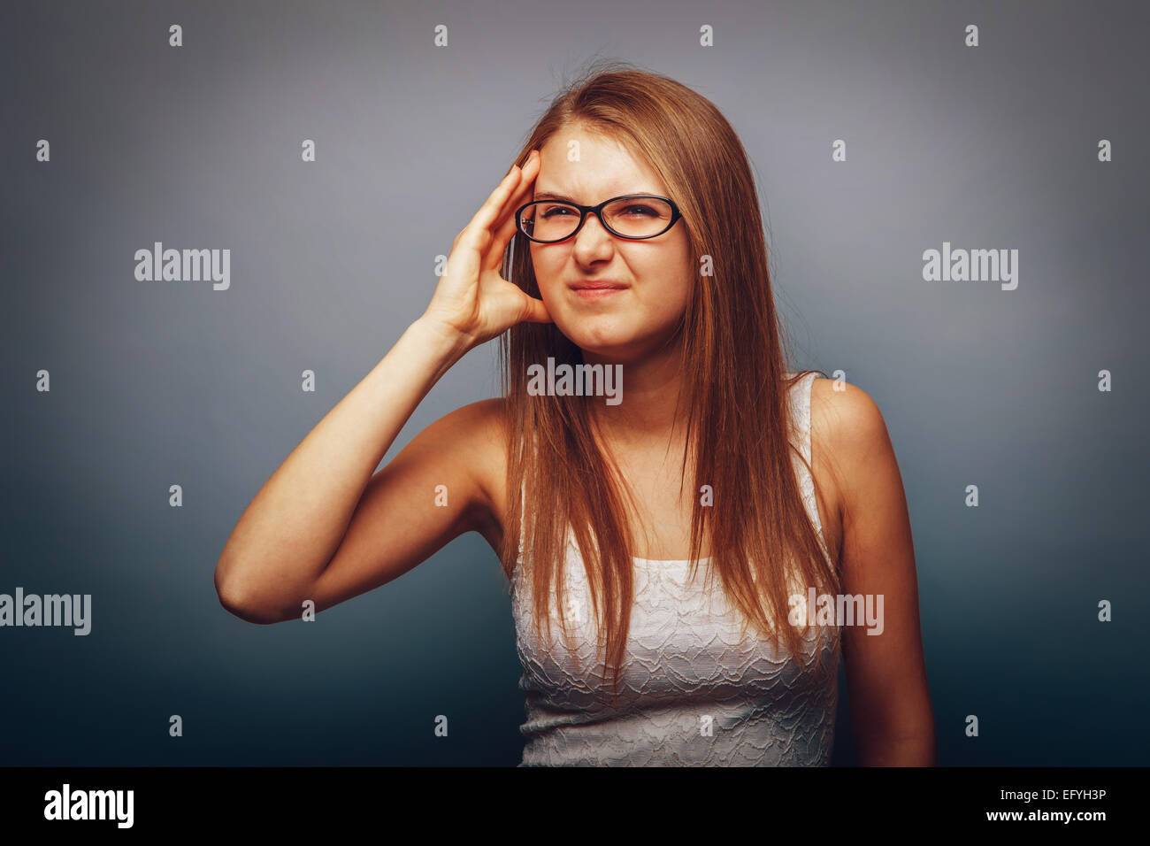 European appearance blonde girl with glasses put a hand to his h Stock ...