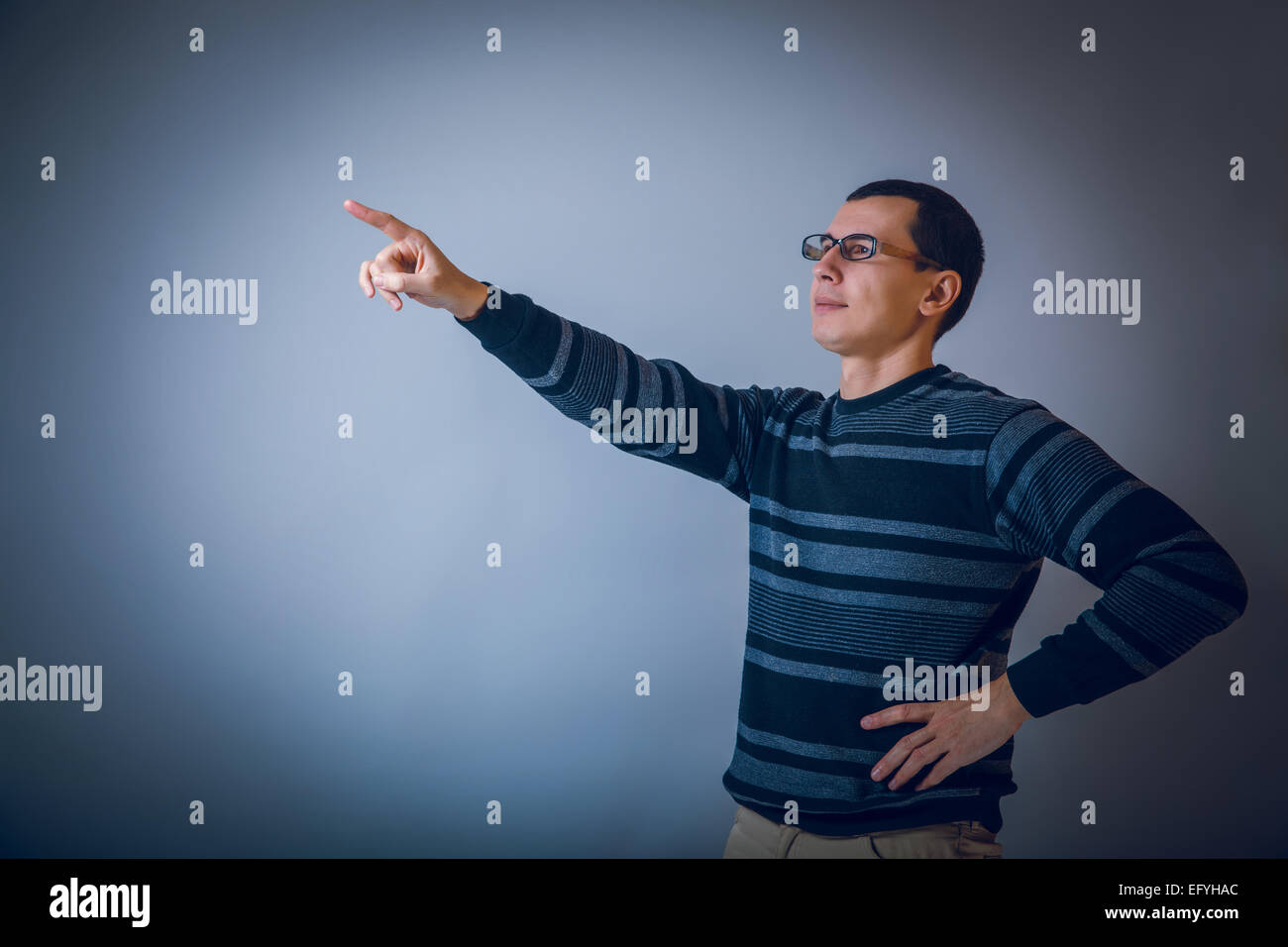 European-looking man with glasses shows his hand forward on a gr Stock ...