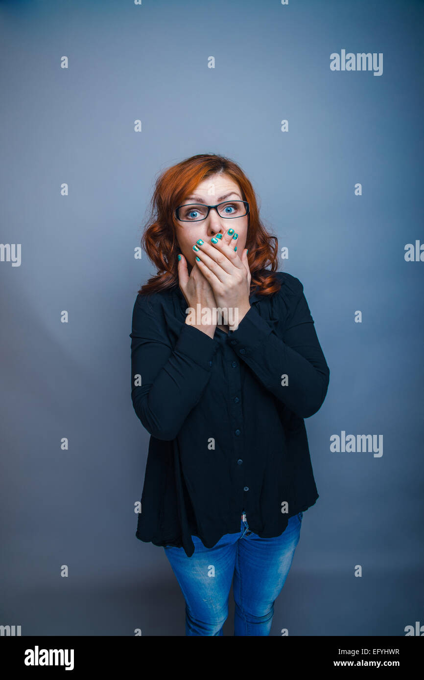 European-looking woman of thirty years covers mouth with her han Stock ...