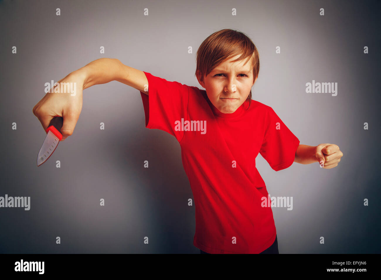 European-looking boy of ten years holding a knife in his hand Stock ...
