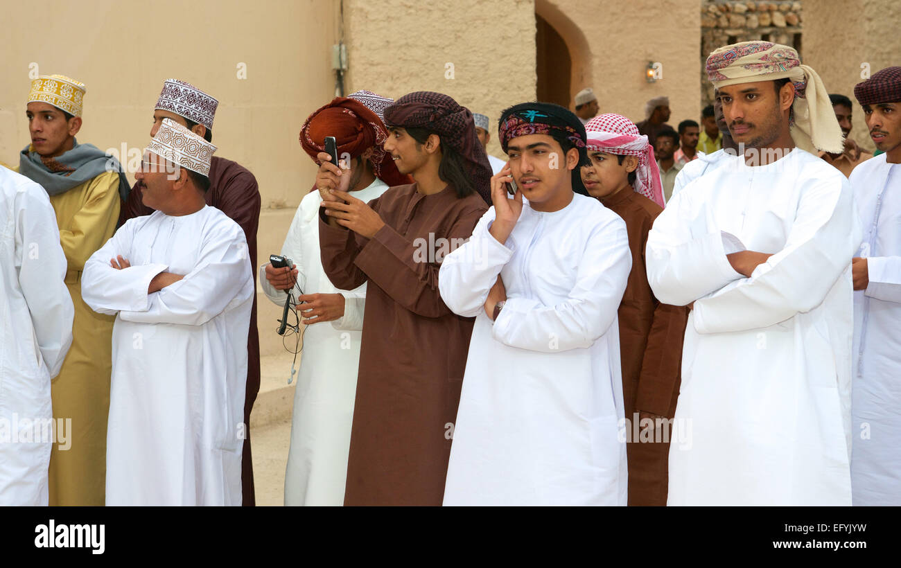 Omani men watching a tribal dance during the annual Muscat Festival, in ...