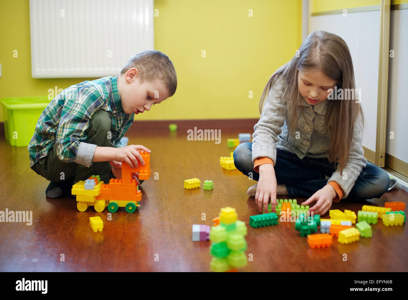 Happy beautiful girl plays with blocks Stock Photo - Alamy