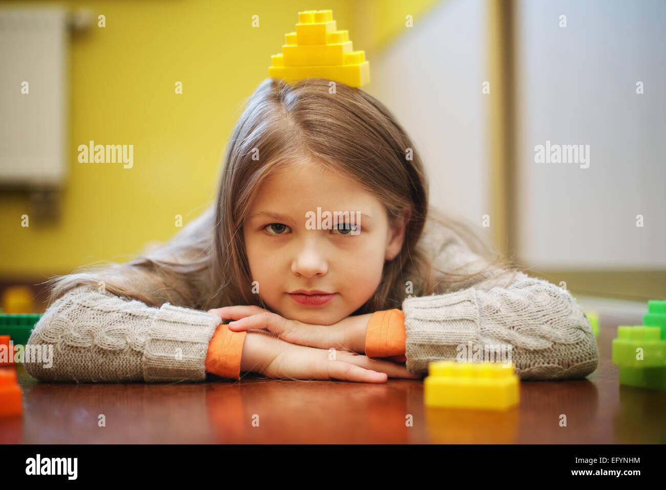 Happy beautiful girl plays with blocks Stock Photo - Alamy