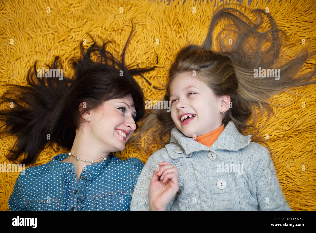 mother with children lying on floor Stock Photo - Alamy