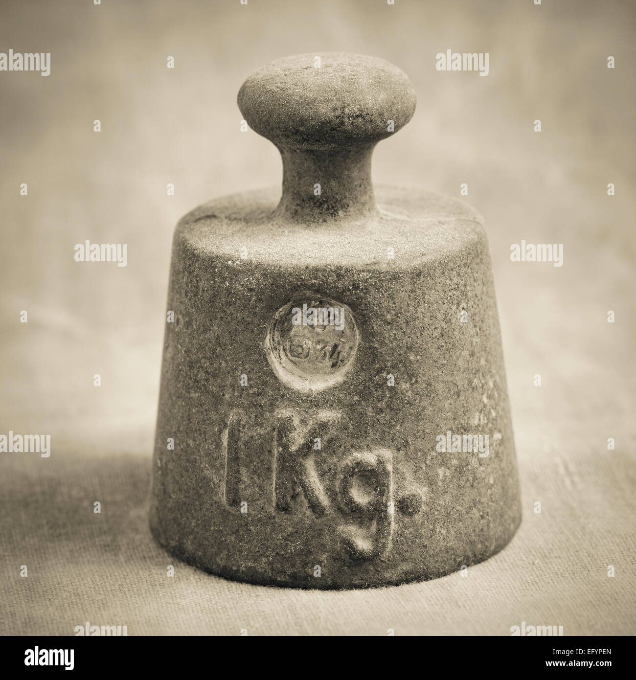 Still life of old fashioned iron weight of one kilogram used for ...