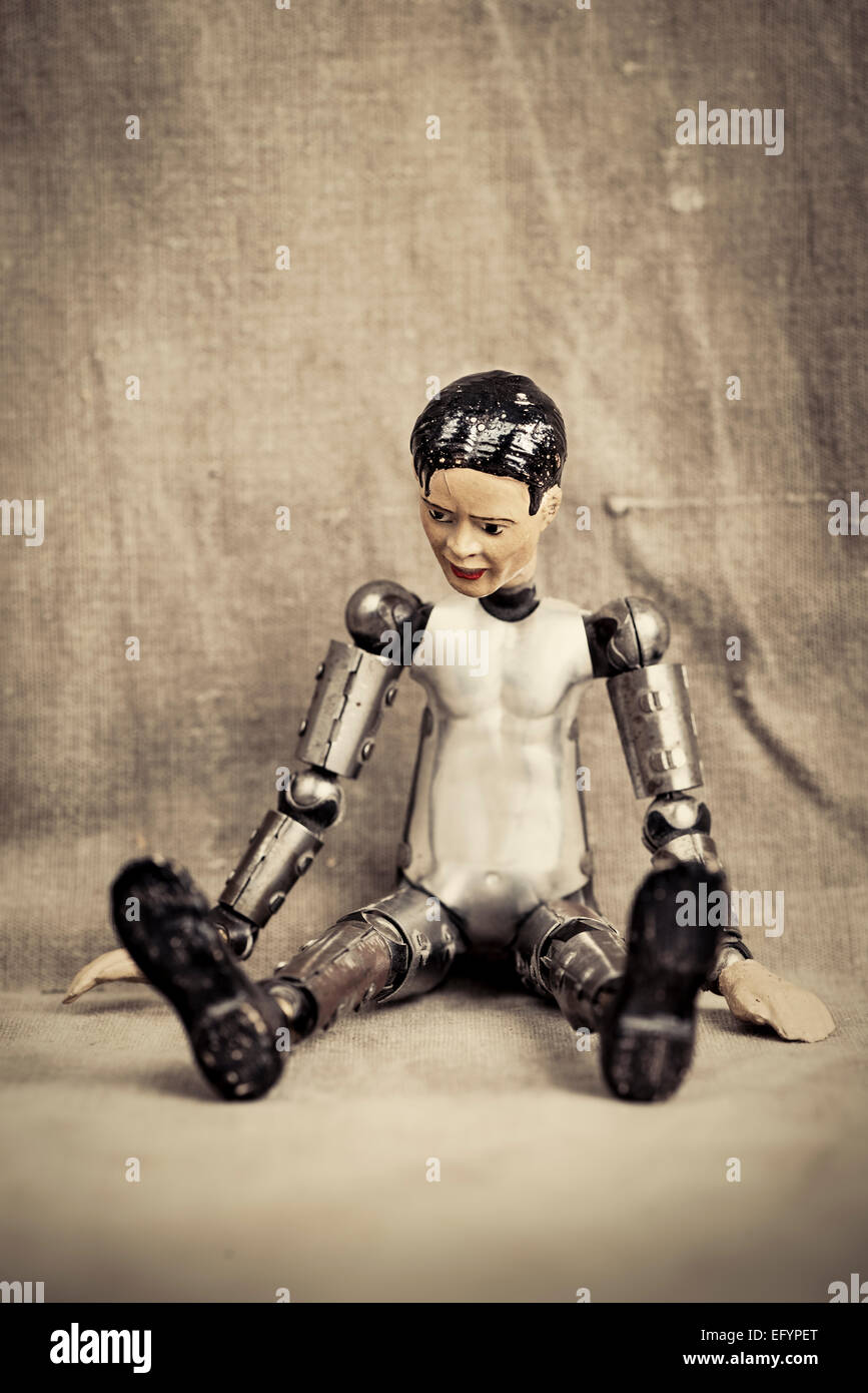 Pensive and depressed male toy doll sitting and looking down. Old ...