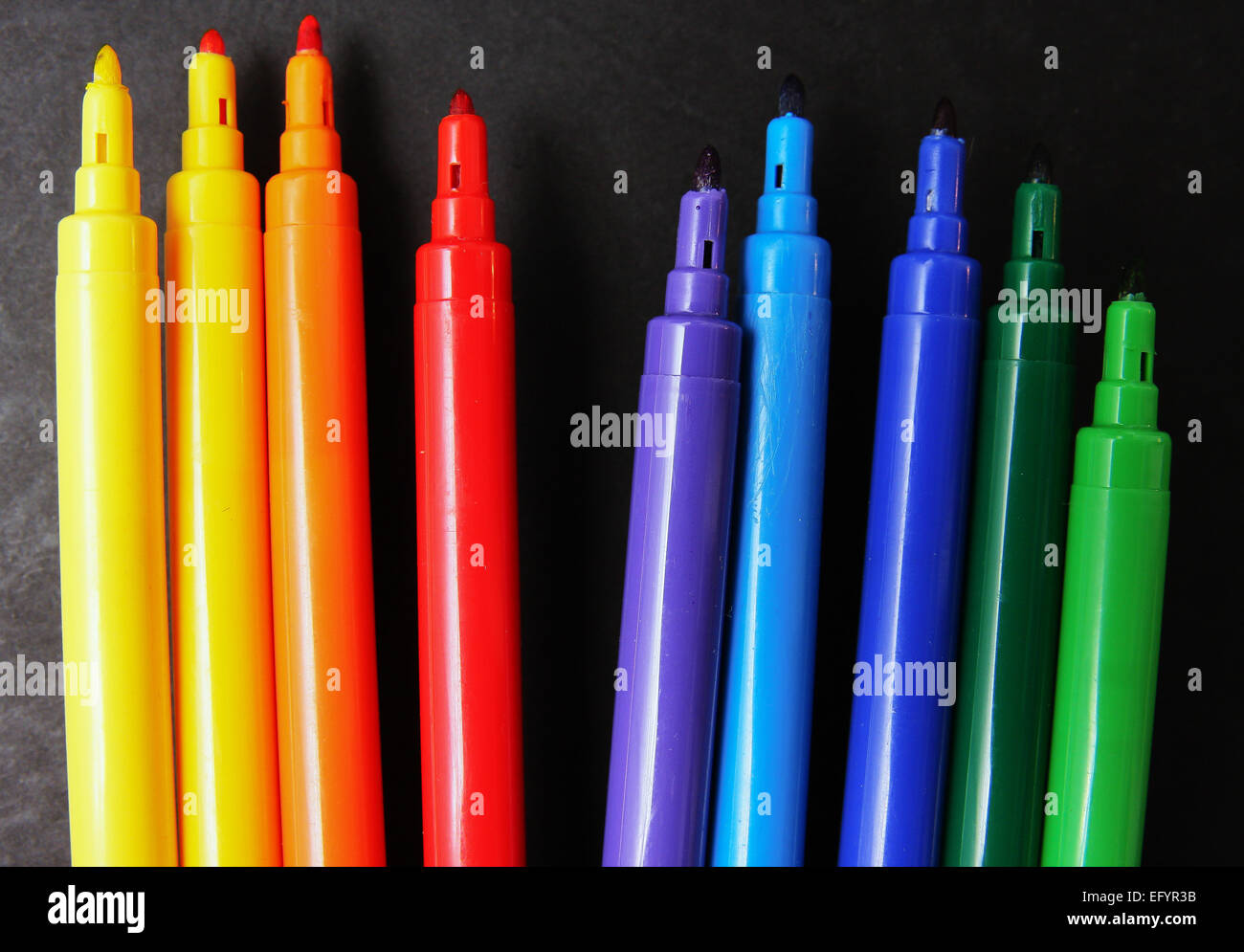 Row Of Colourful Pens On Black Background Stock Photo - Alamy