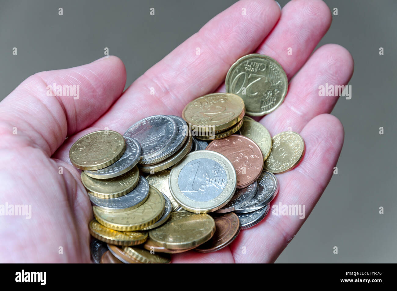 Euro coins in hand Stock Photo - Alamy