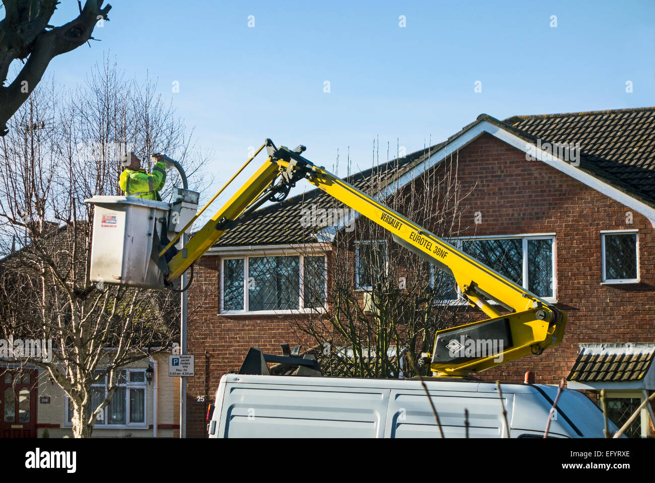 Repairing street light with a cherry picker hi-res stock photography ...