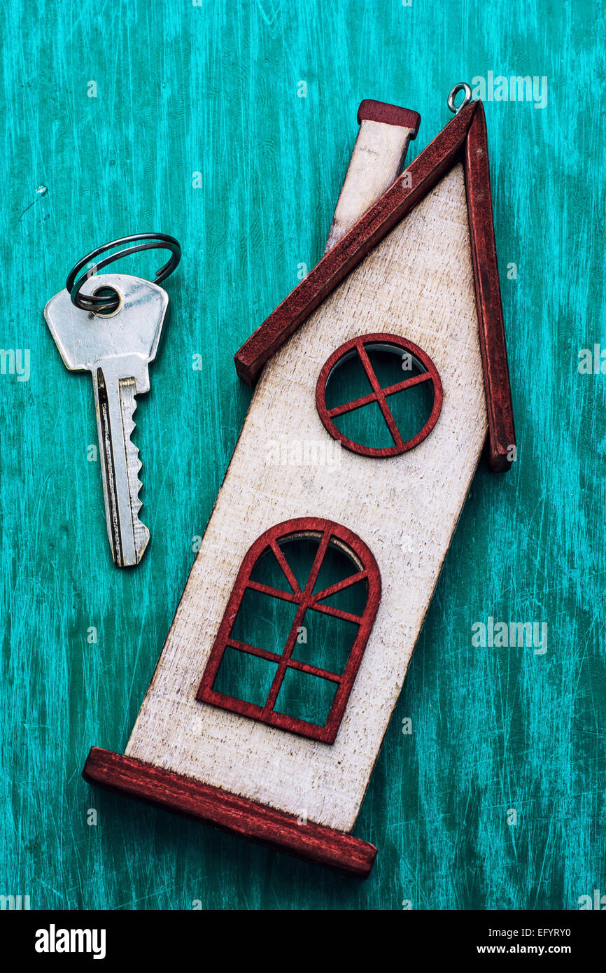 symbolic house and key on wooden background turquoise Stock Photo - Alamy