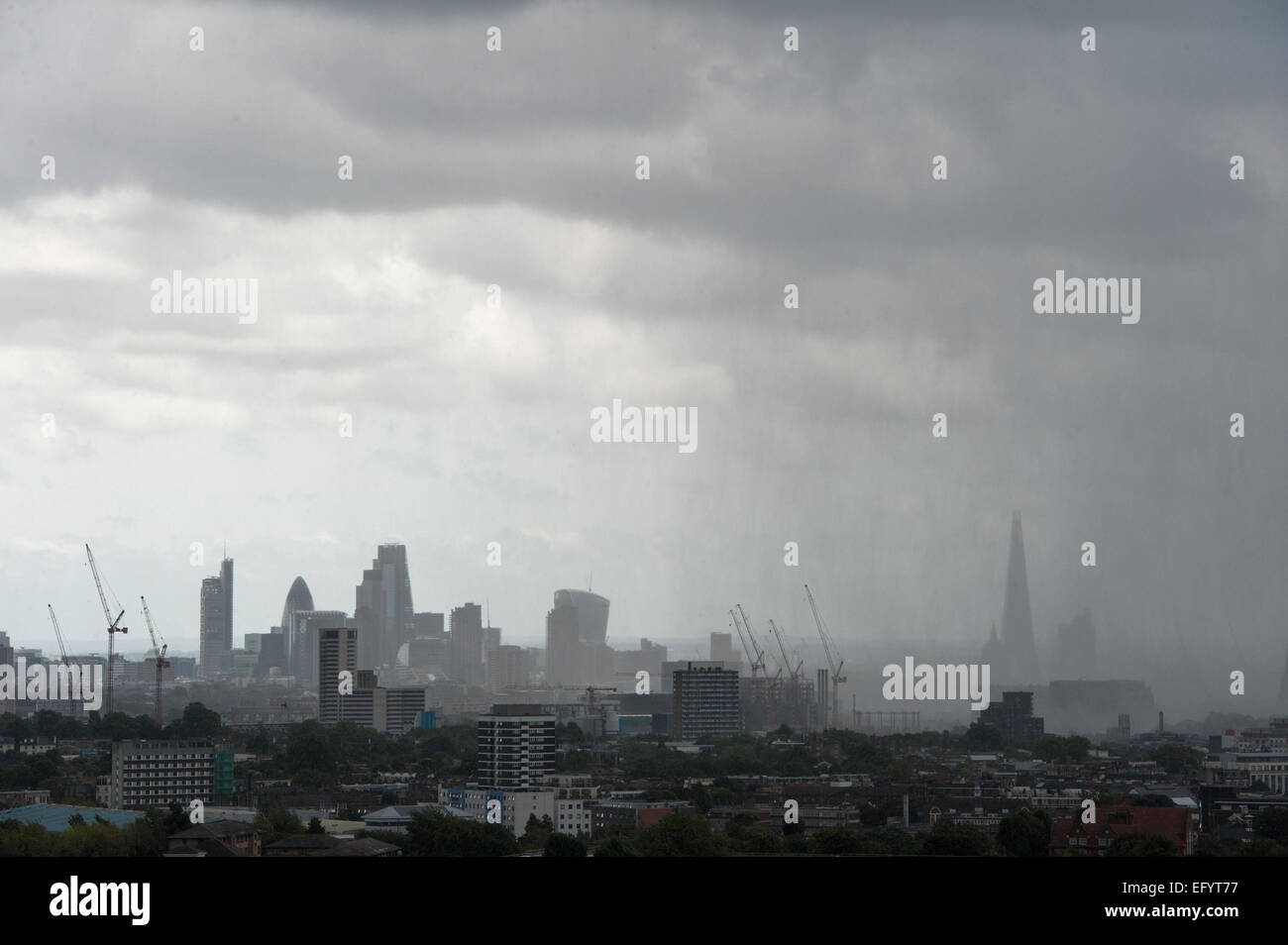 Storm clouds gather and heavy rain falls over the City of London as the ...