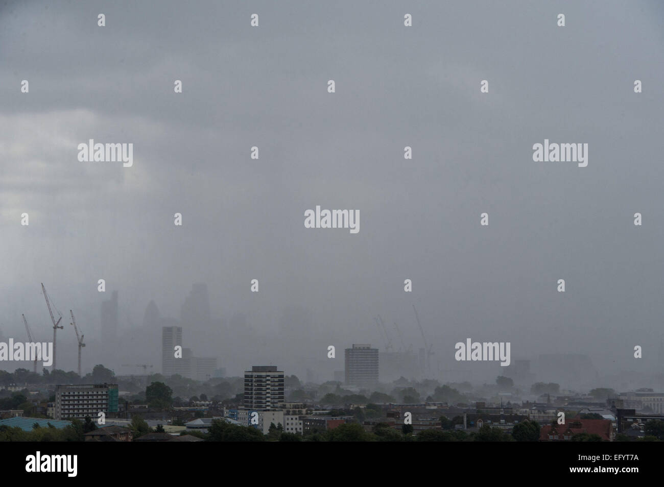 Storm clouds gather and heavy rain falls over the City of London as the ...