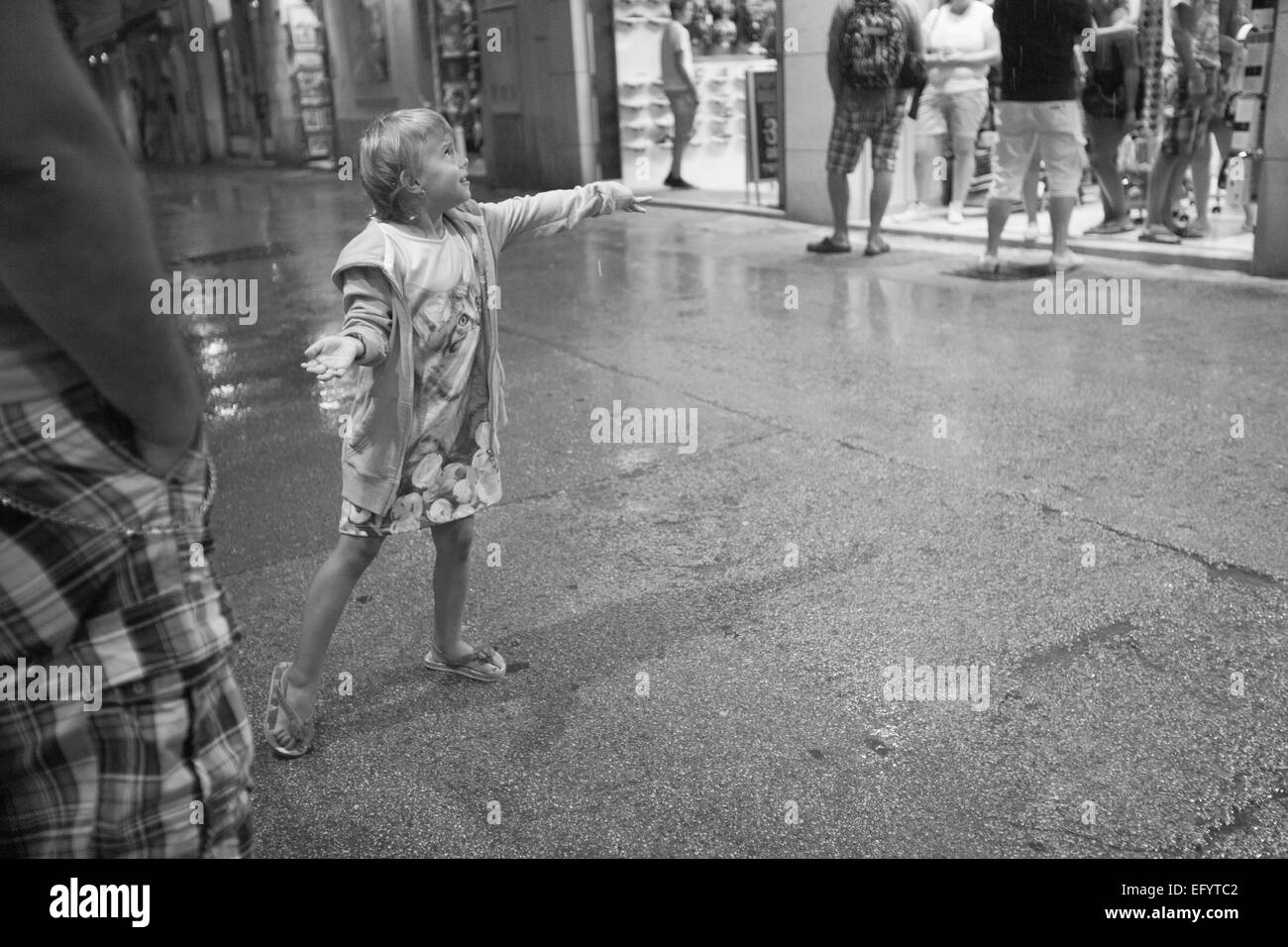 Kid trying rain Stock Photo - Alamy