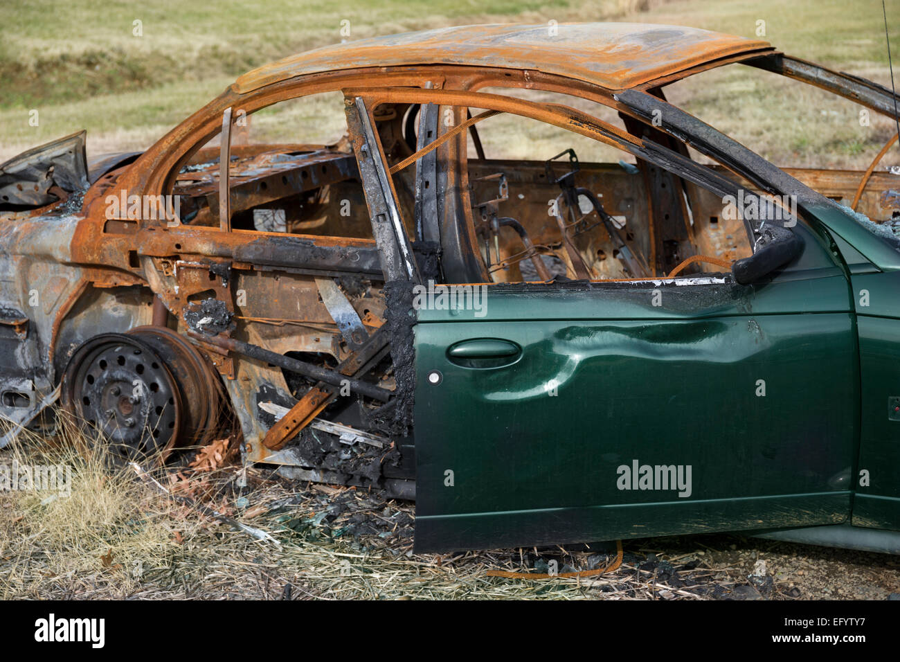 Green car destroyed by fire Stock Photo - Alamy