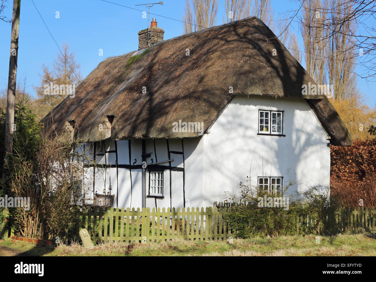 Traditional Thatched English Village Cottage with picket fence Stock ...