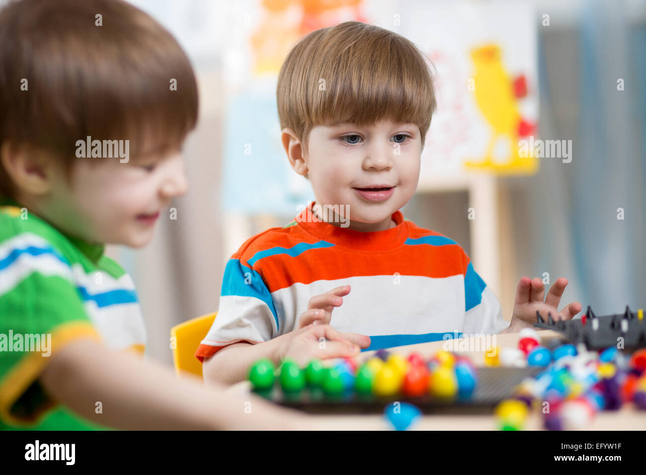 two kids brothers play together at table Stock Photo - Alamy