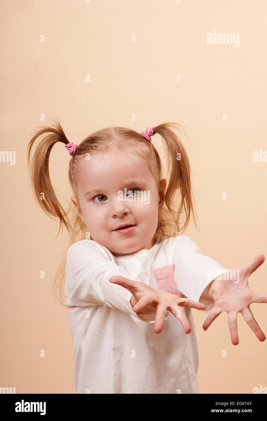 Girl stretching out hands Stock Photo - Alamy