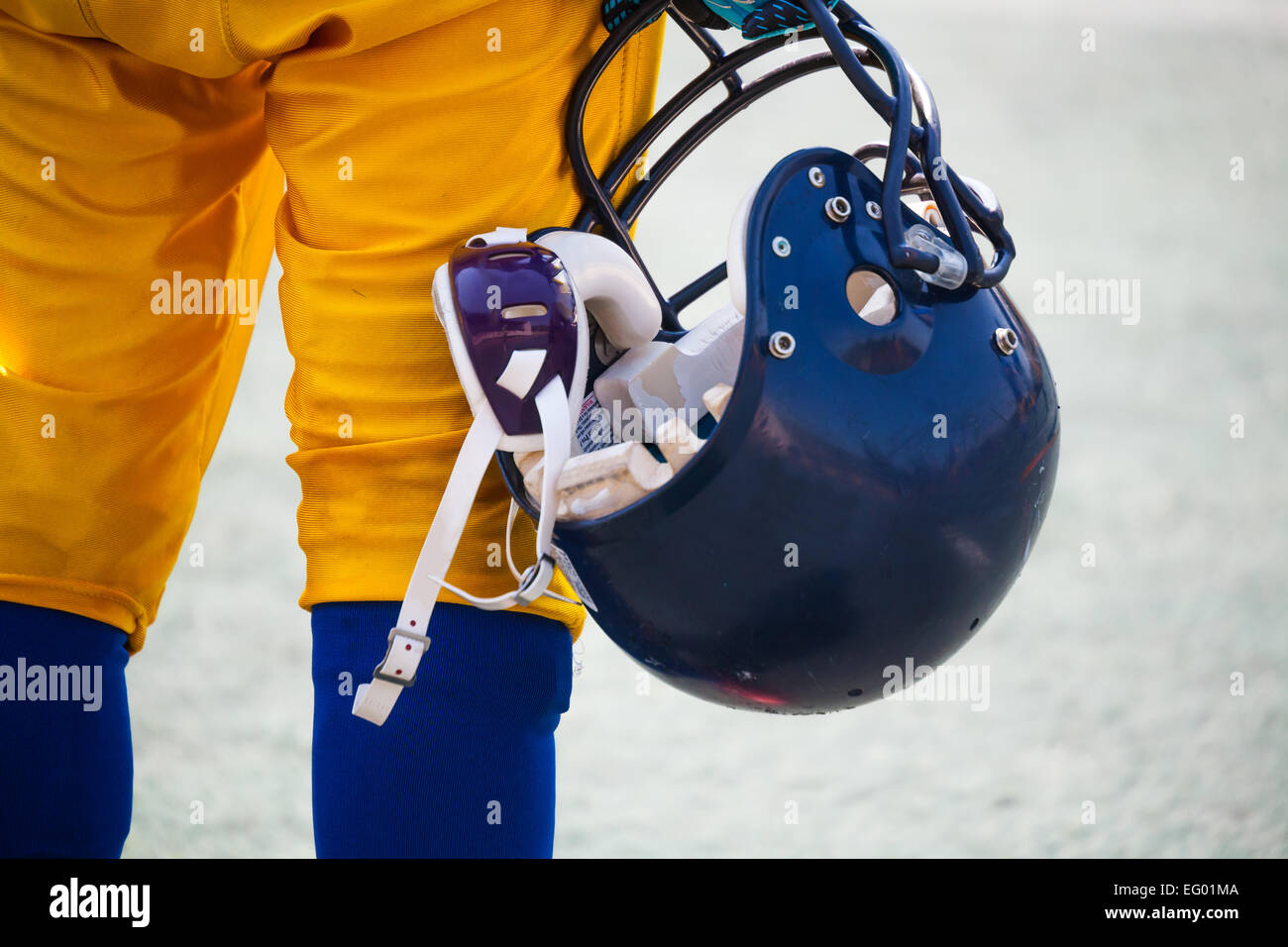 closeup feet in sportswear football and helmet Stock Photo - Alamy