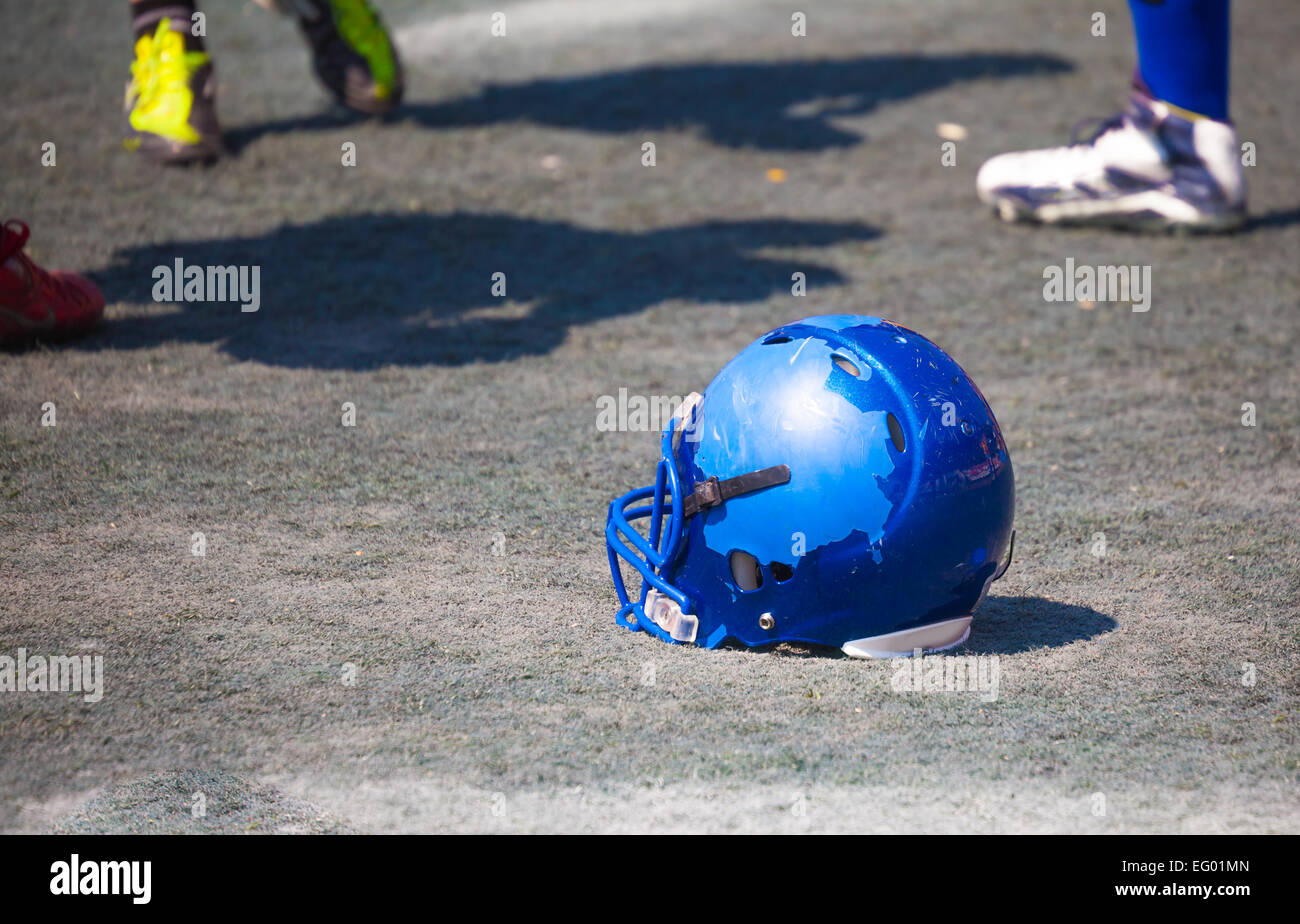 blue helmet lying on the field of stadium Stock Photo - Alamy