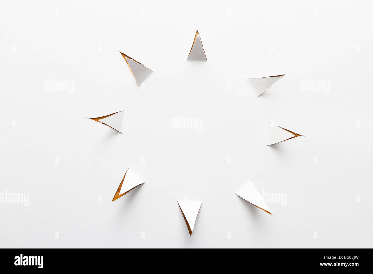 abstract paper cut with triangles around a main circle to form the sun ...