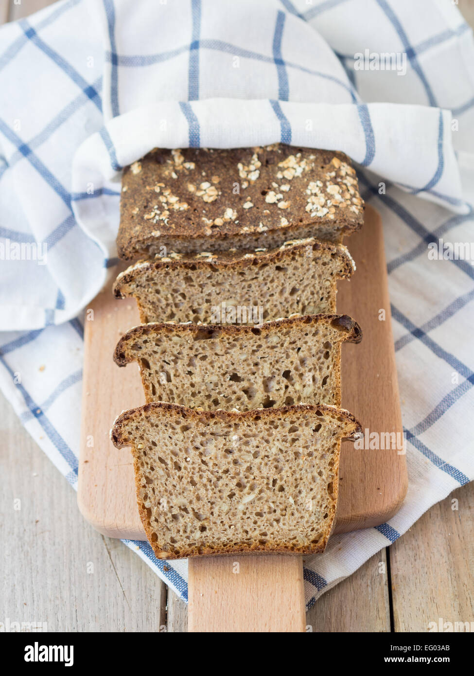 Vertical photo of sliced homemade whole grain mixed rye-wheat sourdough ...