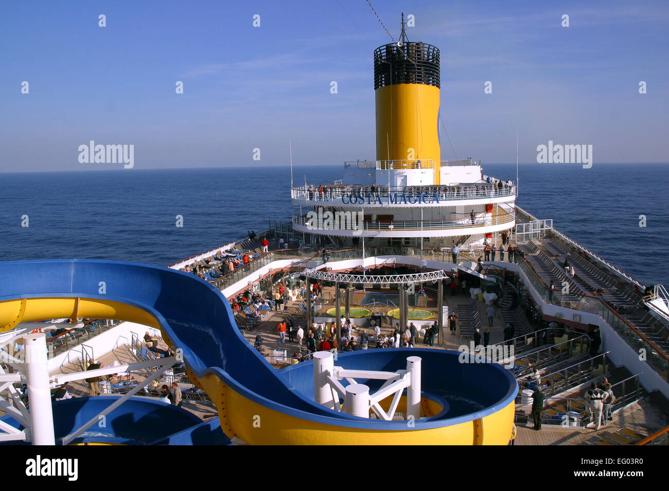 Passengers enjoy a sunny day on the deck cruise ship Costa Magica ...