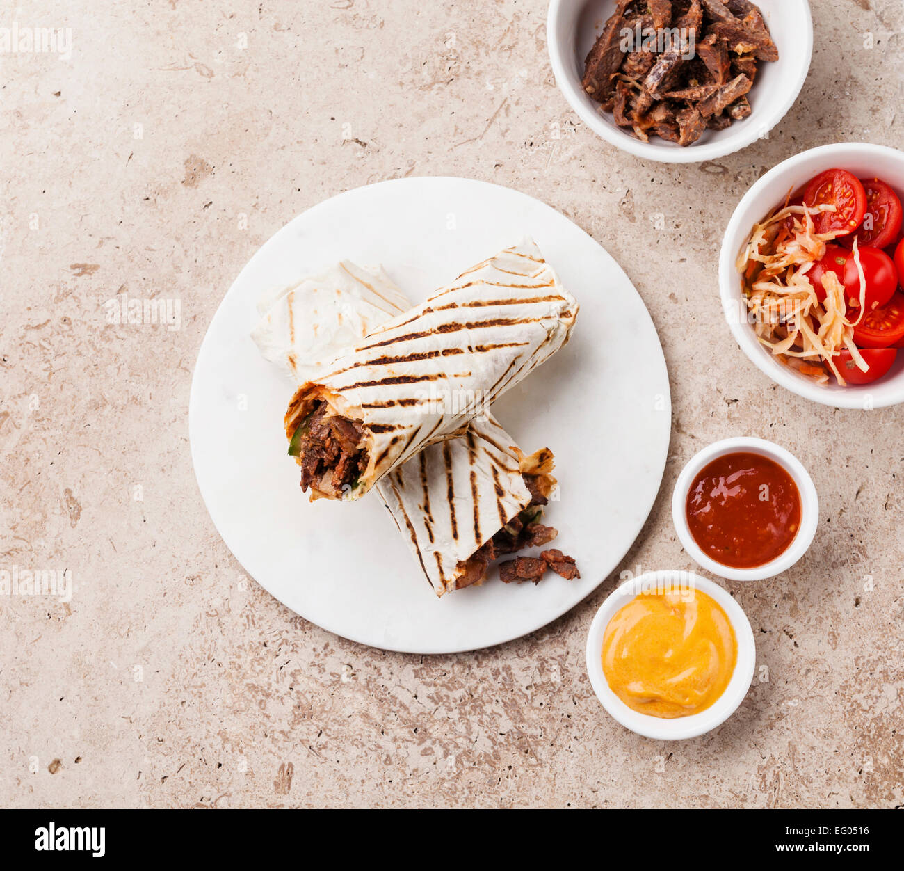 Doner Kebab grilled meat and vegetables on stone textured background ...