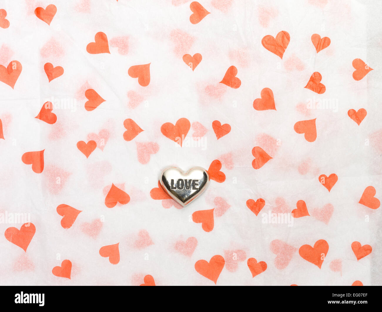 silver love heart on paper background Stock Photo - Alamy