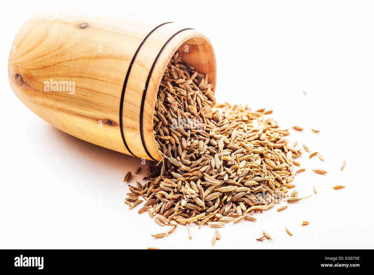 spice cumin in a wooden bowl on a white background Stock Photo - Alamy