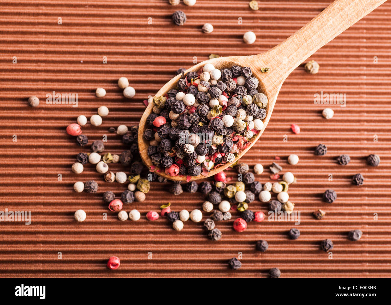 pepper in a wooden spoon on a brown background Stock Photo - Alamy
