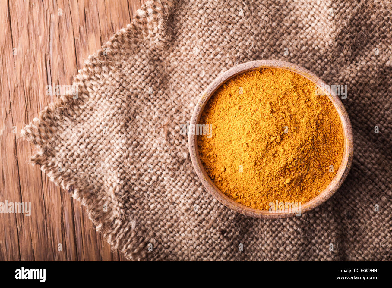 dry spice turmeric in a wooden bowl on a vintage background Stock Photo ...