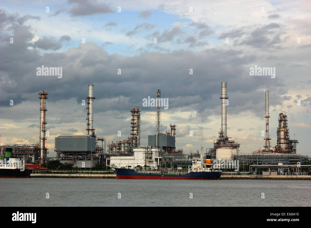 Oil refinery with thunderstorm background Stock Photo - Alamy