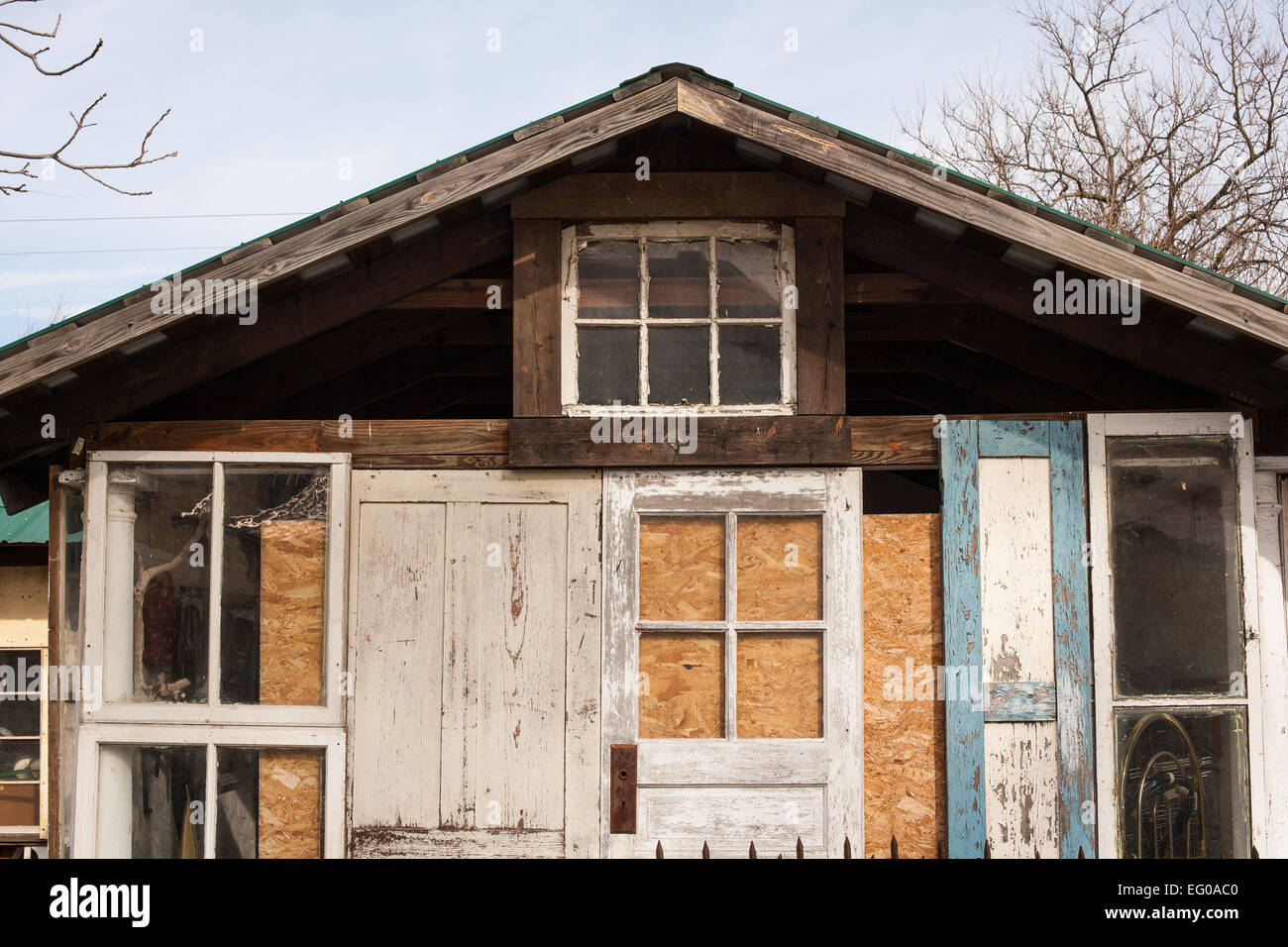 Shed with walls made of old doors and windows at antique shop Stock ...