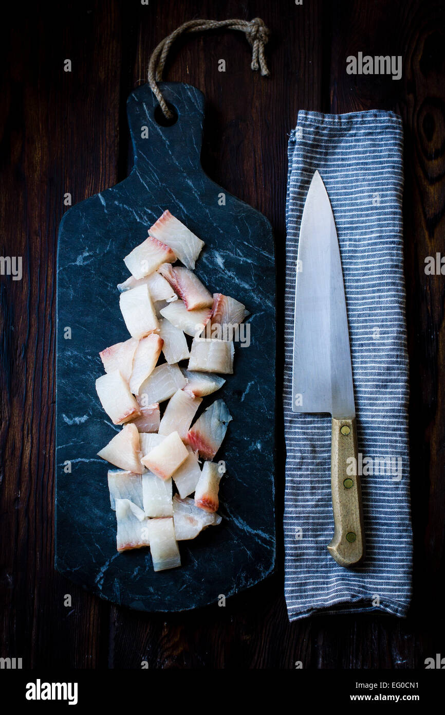 Chopped fish on a marble chopping board Stock Photo - Alamy