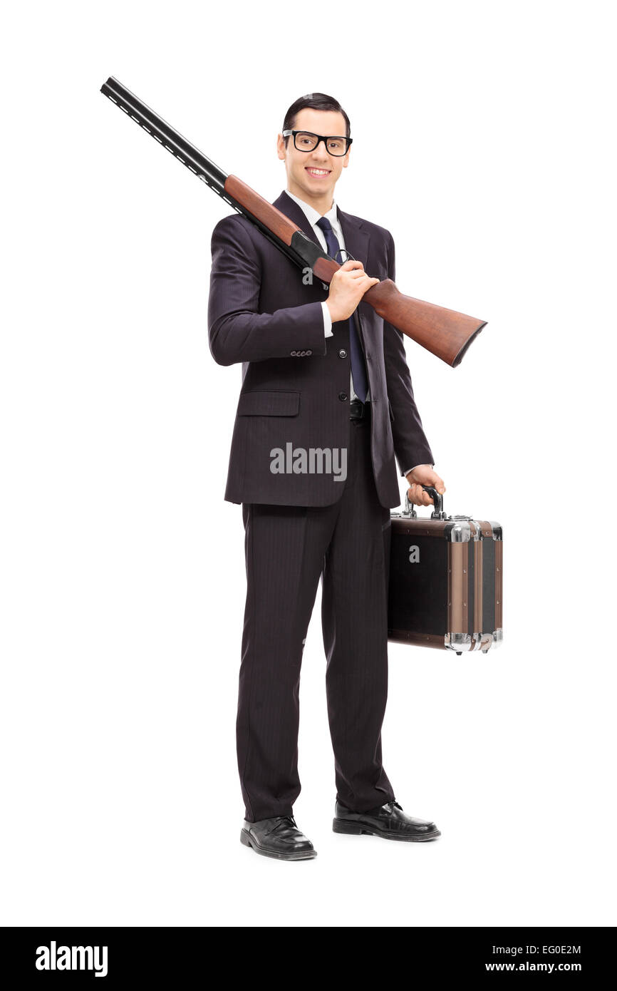 Full length portrait of a businessman holding a rifle and a briefcase ...